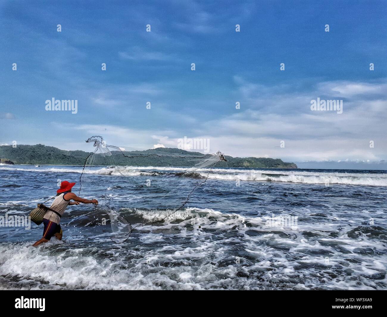 Man Throwing Fishing Net Into Water Stock Photos & Man Throwing Fishing ...