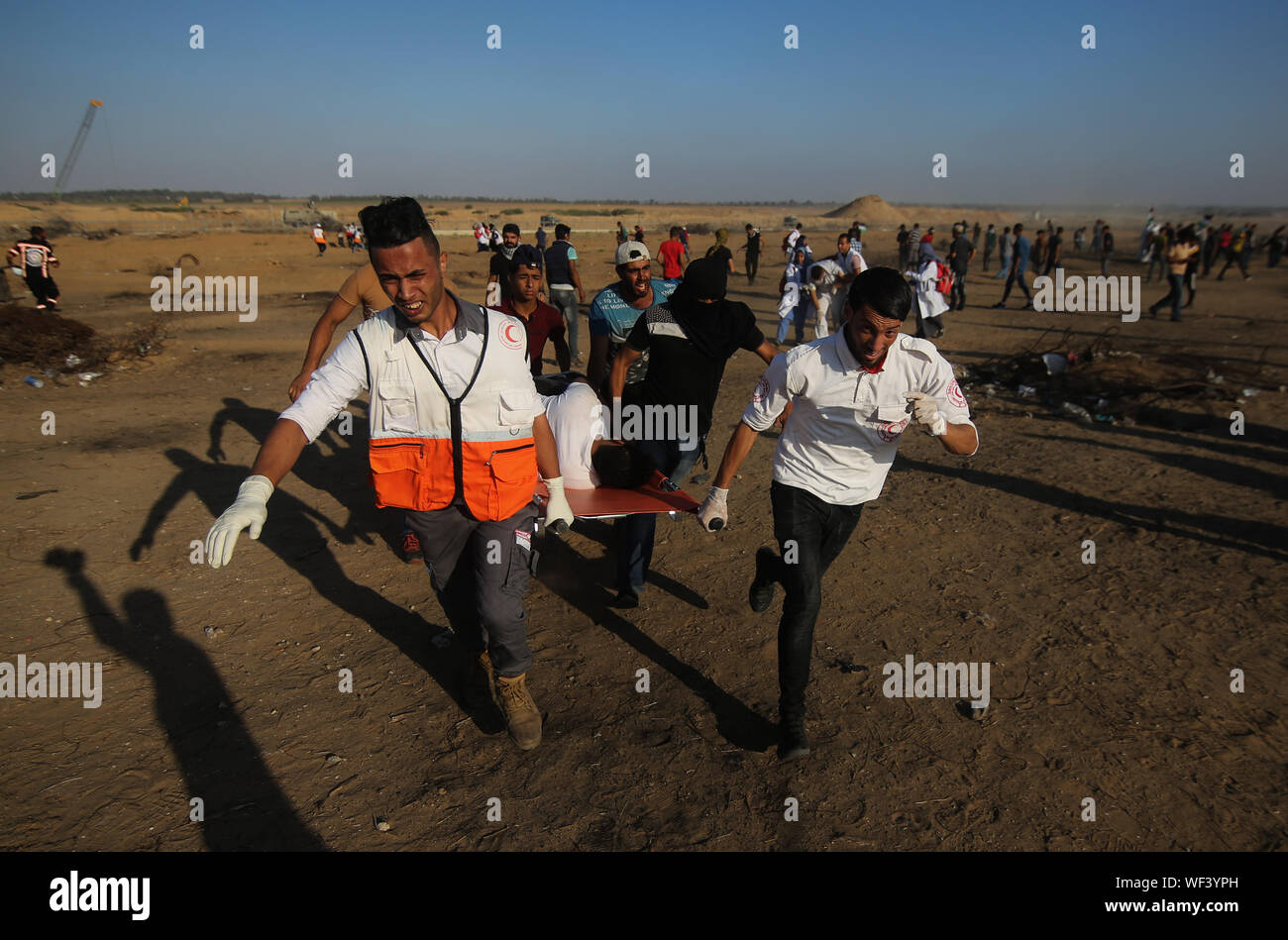 Gaza, Palestine. 30th Aug, 2019. Palestinian medics carry a wounded ...