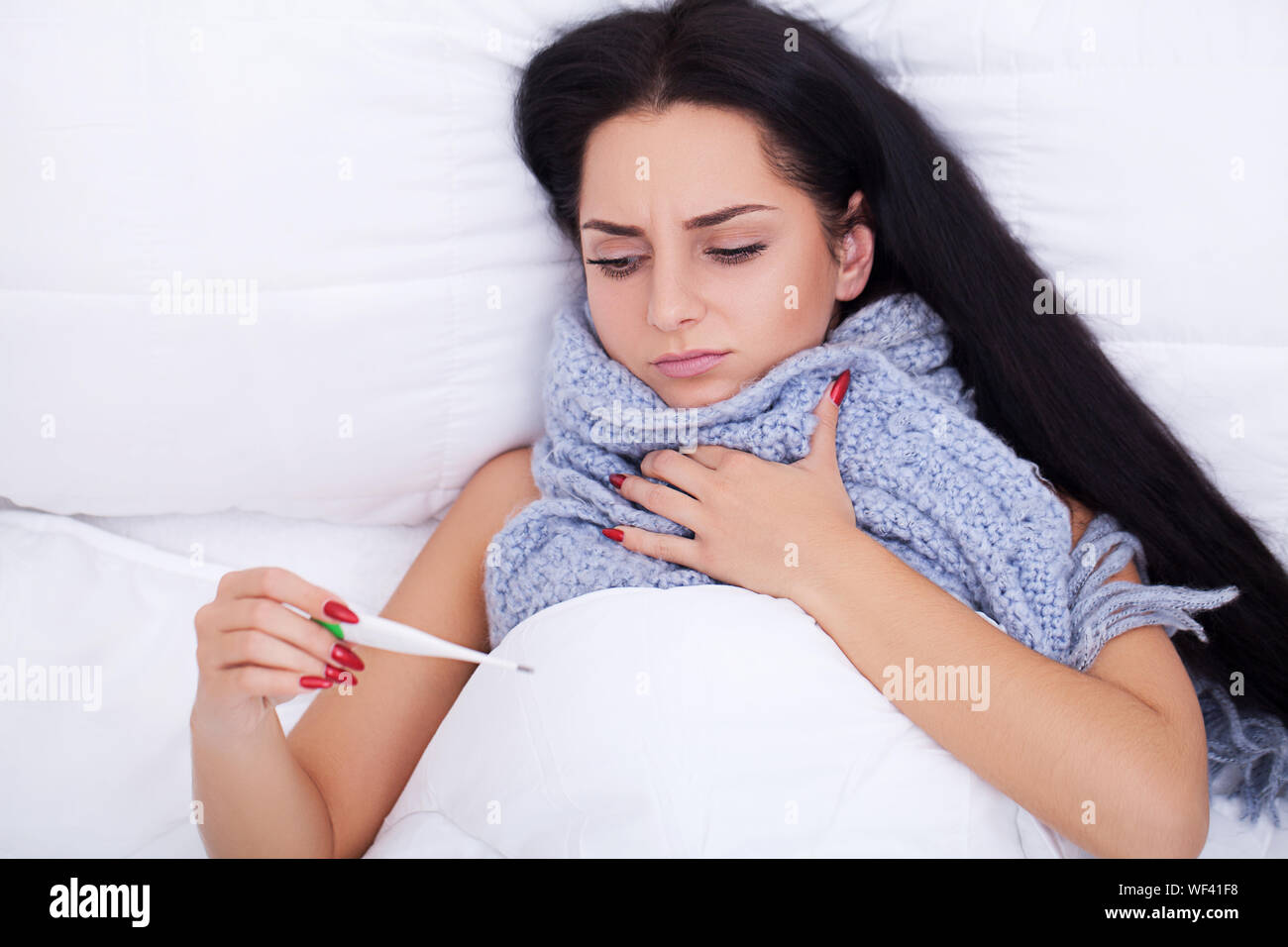 Sick young woman is coughing on the bed Stock Photo - Alamy