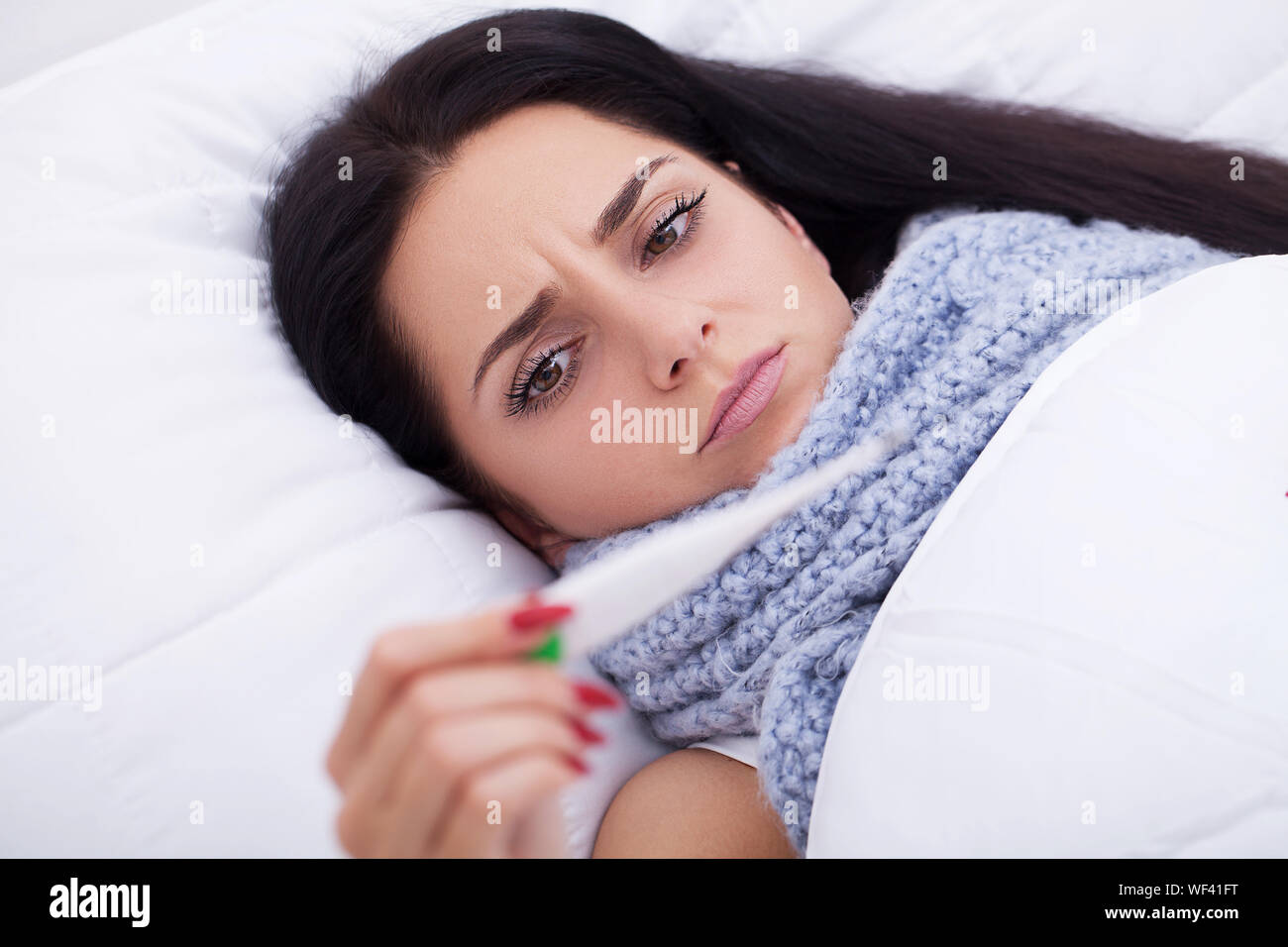 Sick young woman is coughing on the bed Stock Photo - Alamy