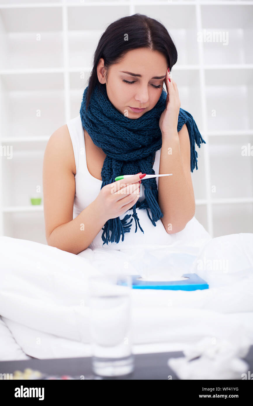 Sick young woman is coughing on the bed Stock Photo - Alamy