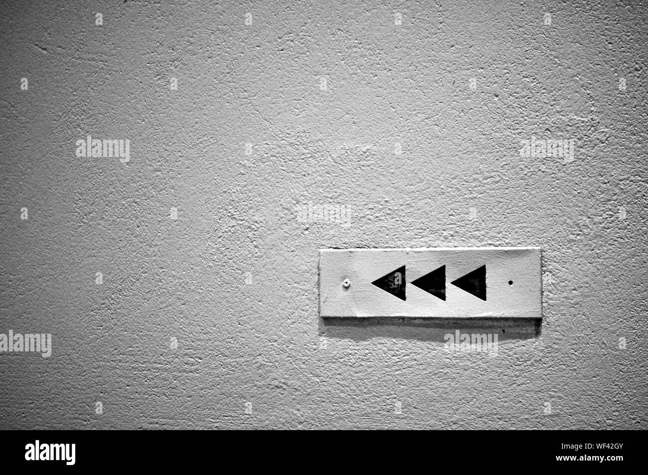 Arrow Symbol On Wall Stock Photo - Alamy