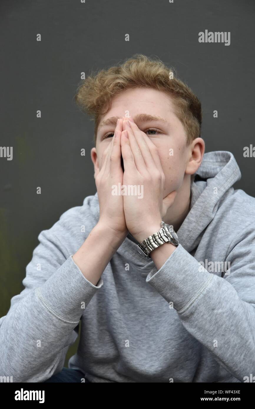 Boy hand covering face hi-res stock photography and images - Alamy