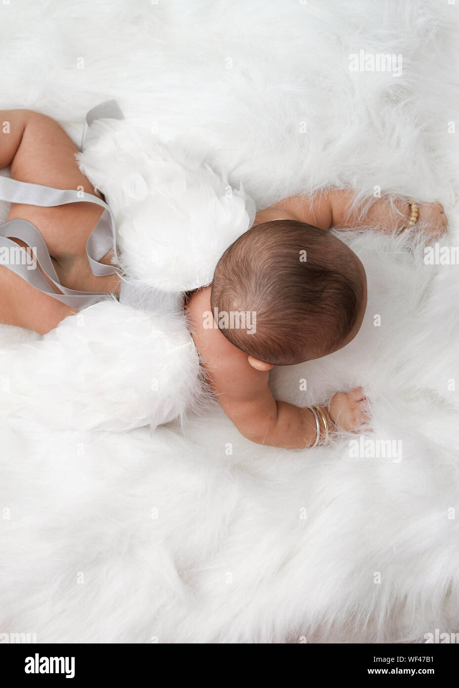 Baby lying on fur rug hi-res stock photography and images - Alamy