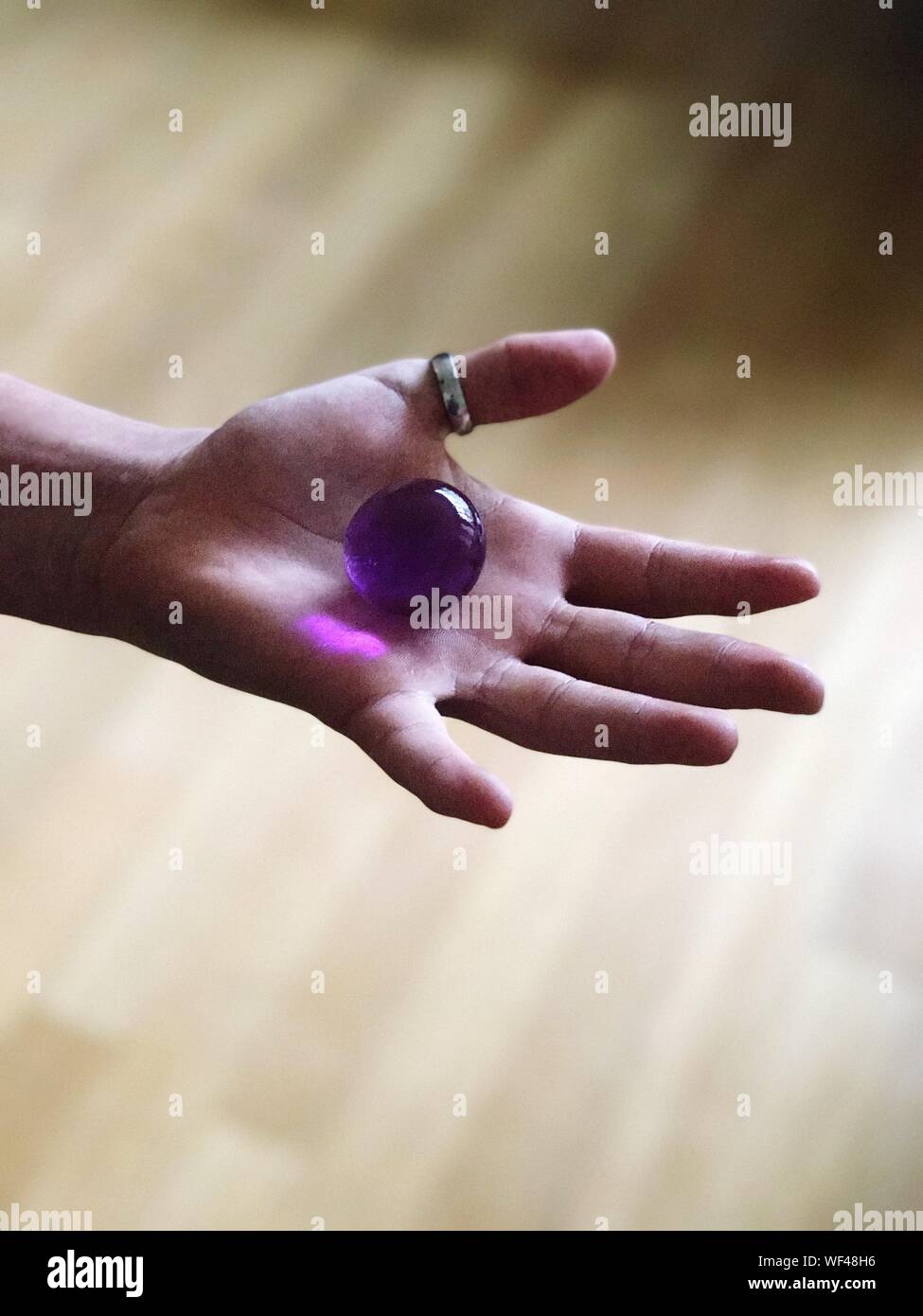 Hand holding marbles hi-res stock photography and images - Alamy