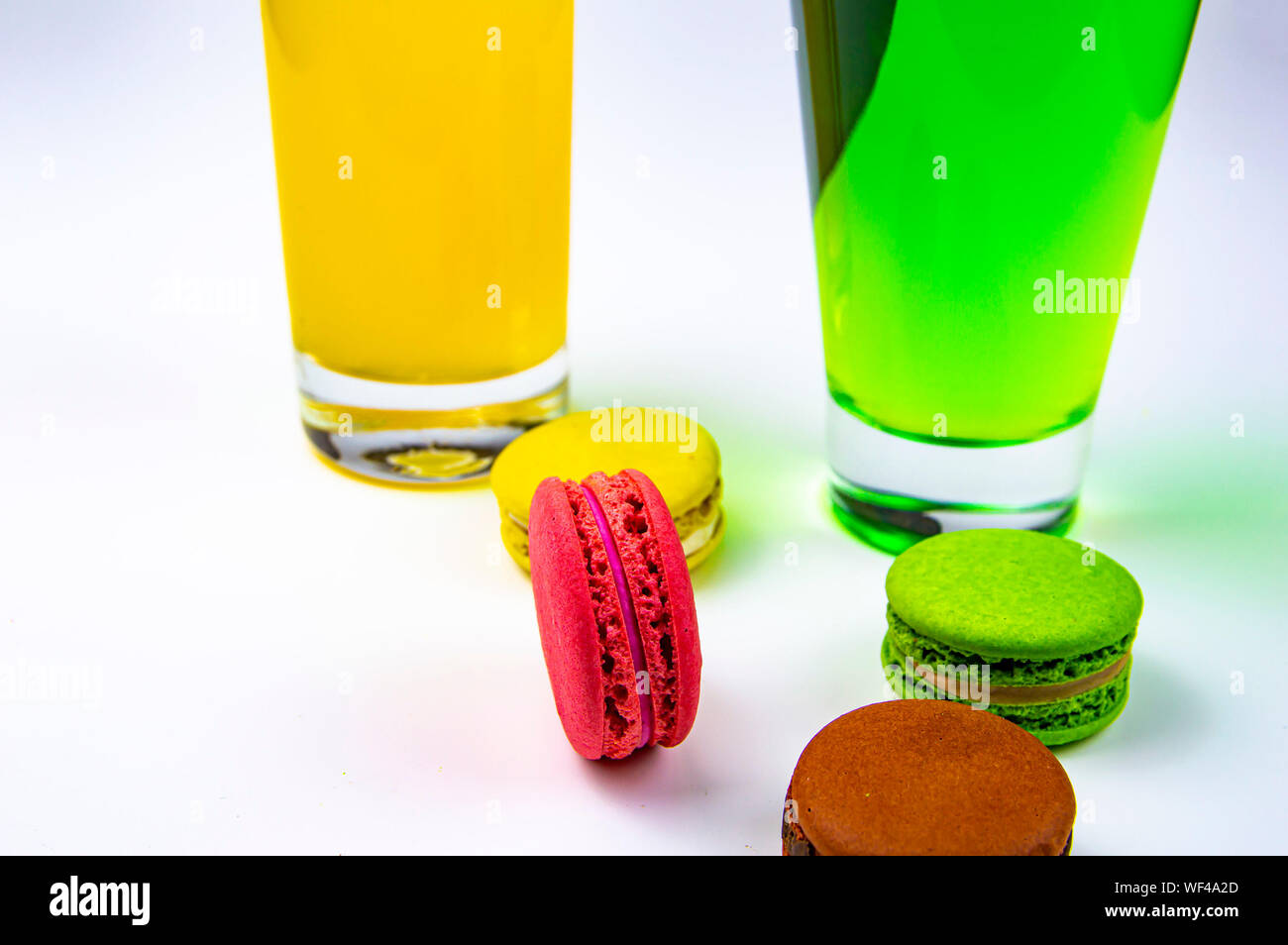 Round color cookies and juice in a glass on a white background. Dessert ...