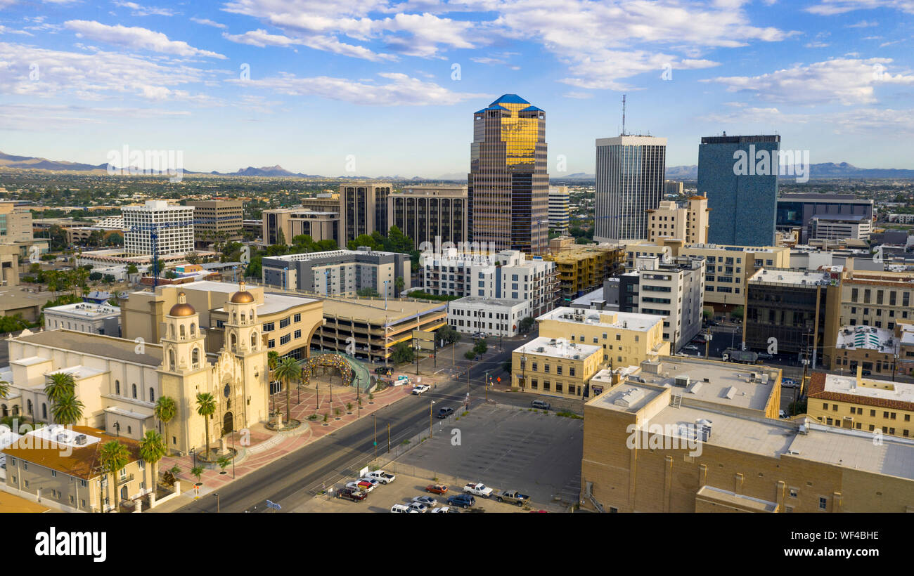 Golden light reflects off the buildings in the downtown city center of ...