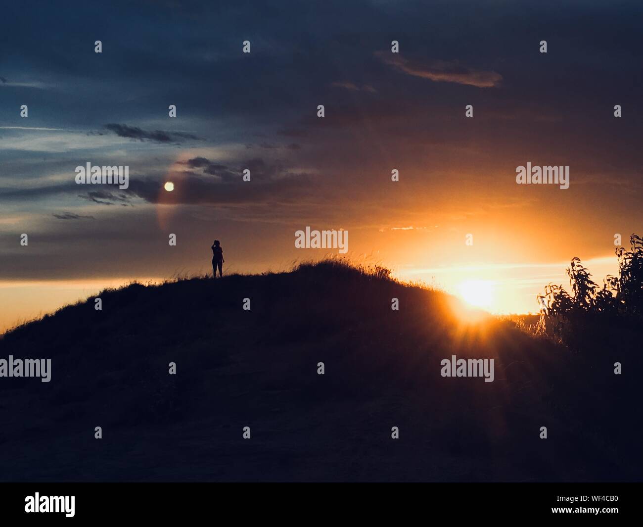 Silhouette Person Standing On Landscape Against Sunset Sky Stock Photo ...