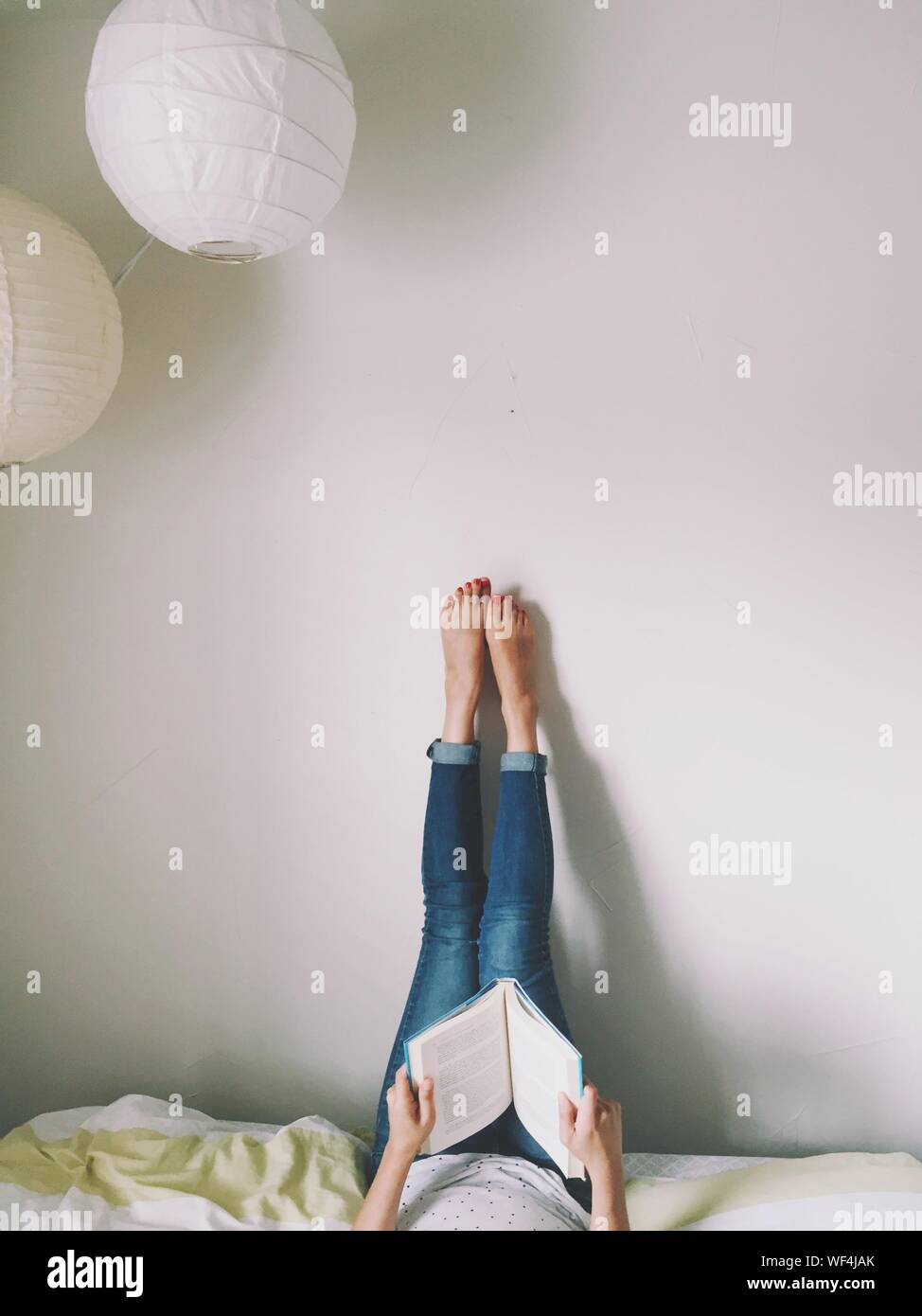 Woman lying on back legs up hi-res stock photography and images - Alamy