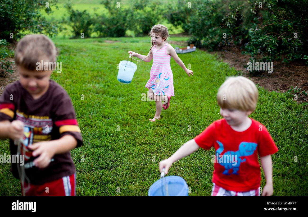 Girls Carrying Bucket High Resolution Stock Photography and Images - Alamy