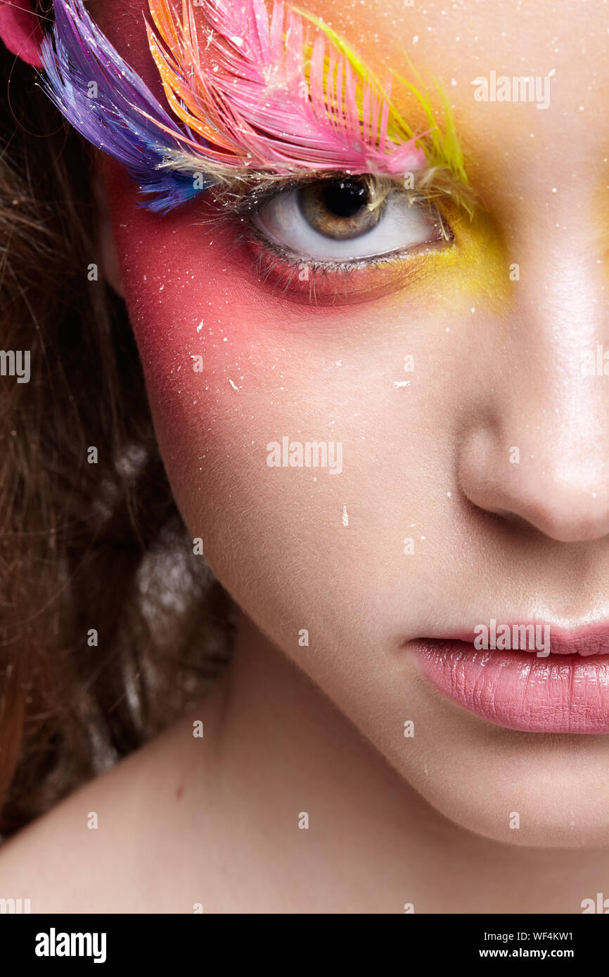 Girl looking sneakily. Close-up shot of female face. Woman with bright ...