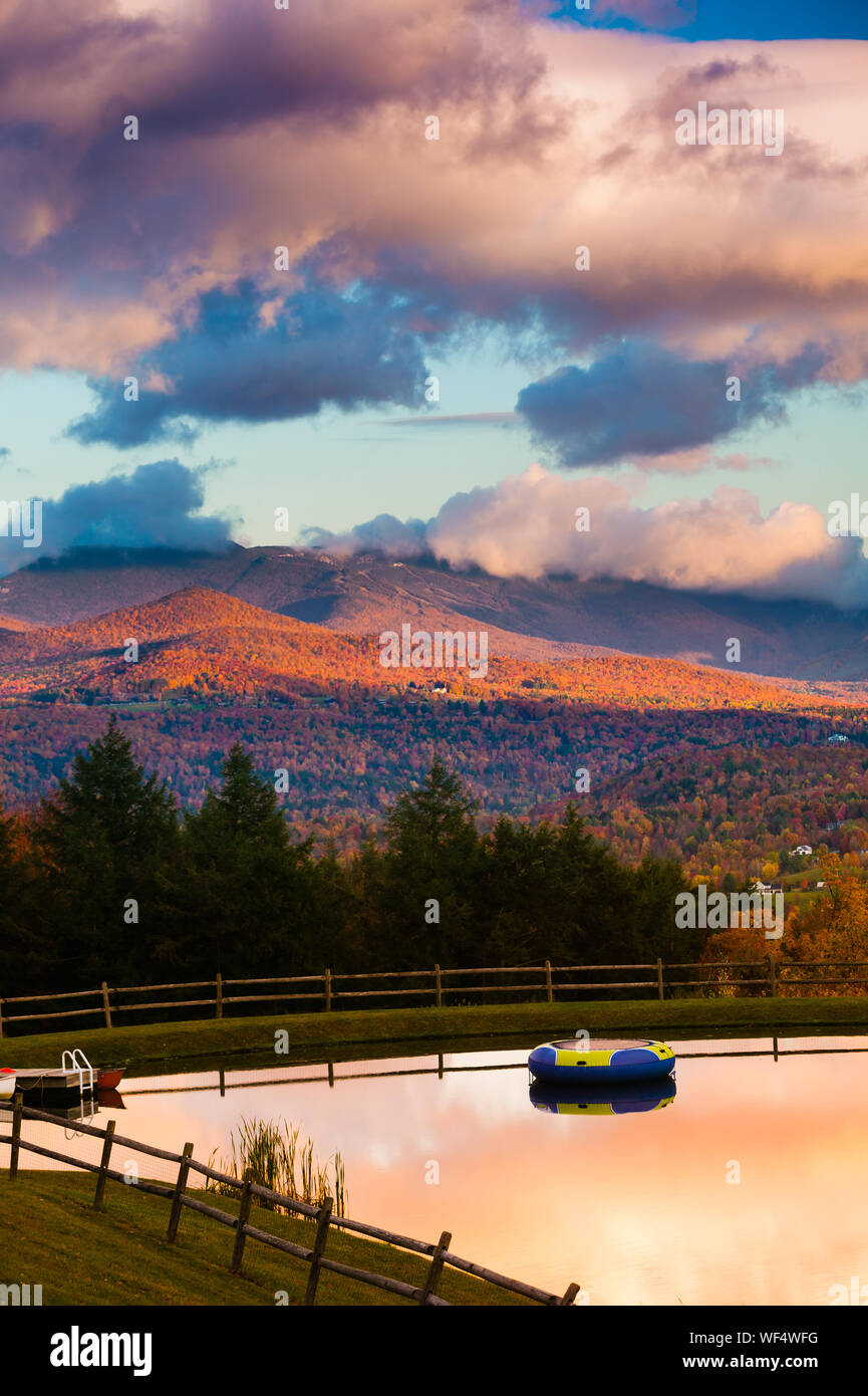 Overlooking a swimming pond with Mt. Mansfield during fall foliage in ...