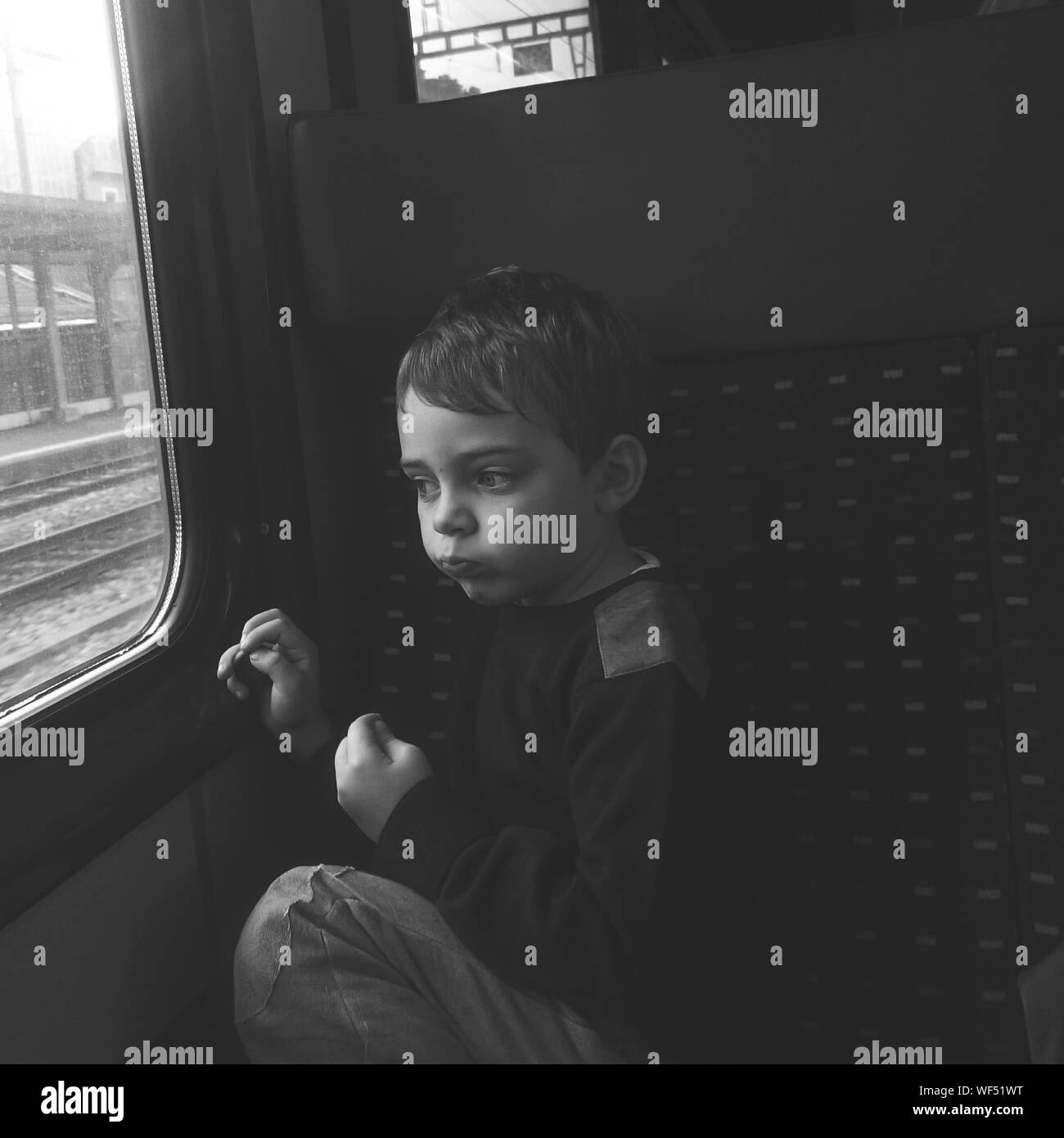 Boy Traveling In Train Stock Photo - Alamy