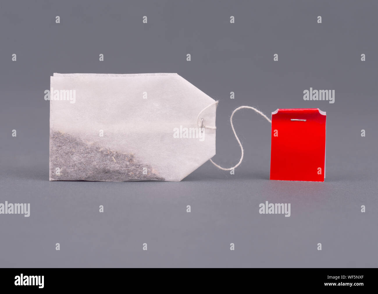 Close-up tea bag on grey background mock up Stock Photo - Alamy