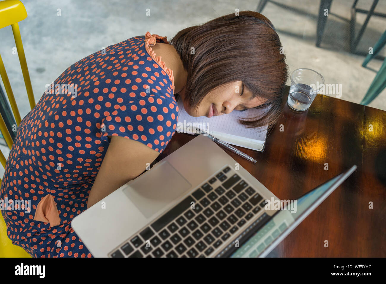 Asian office woman sleeping in the office Stock Photo - Alamy