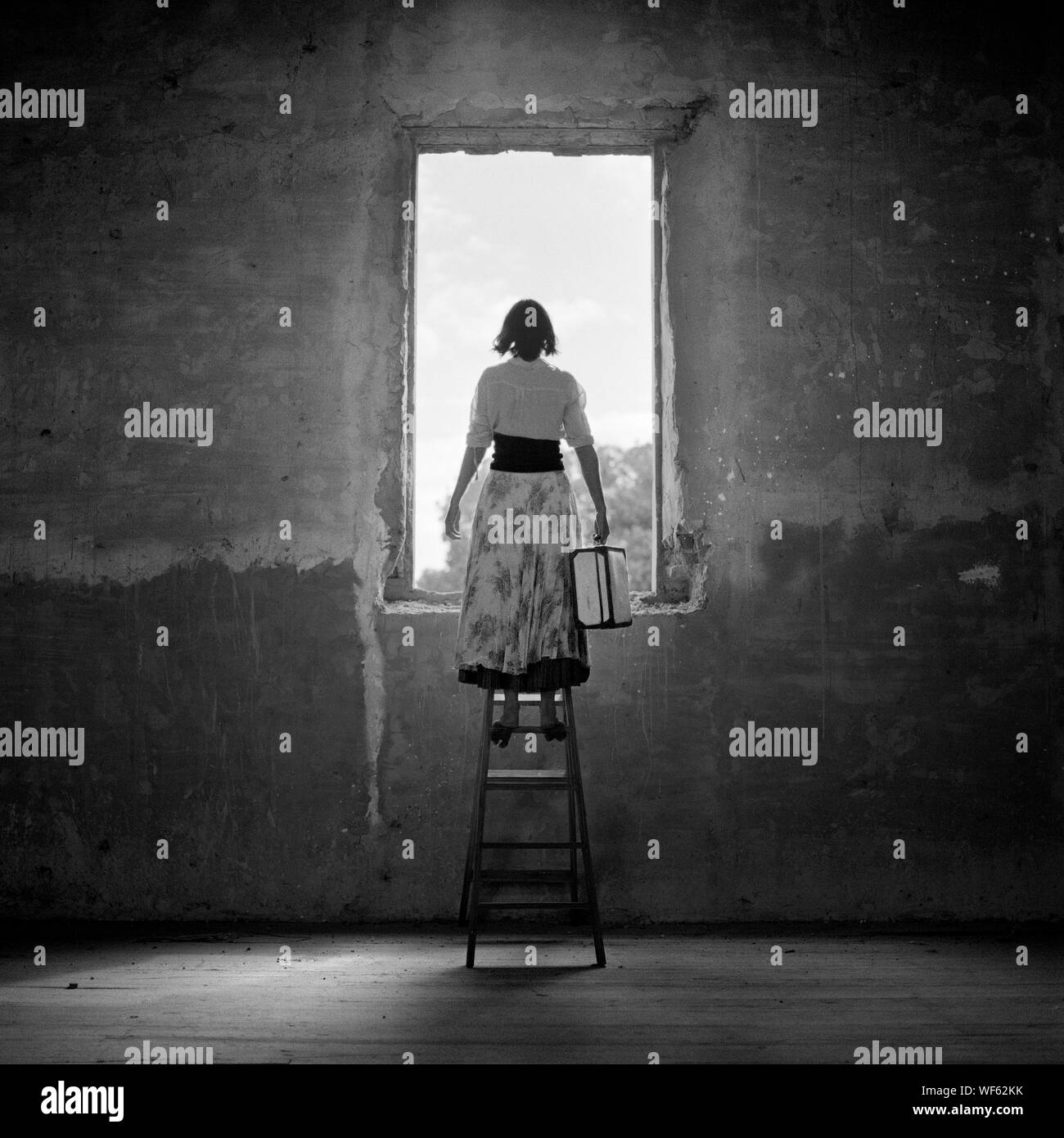 Woman leaving through window Black and White Stock Photos & Images - Alamy