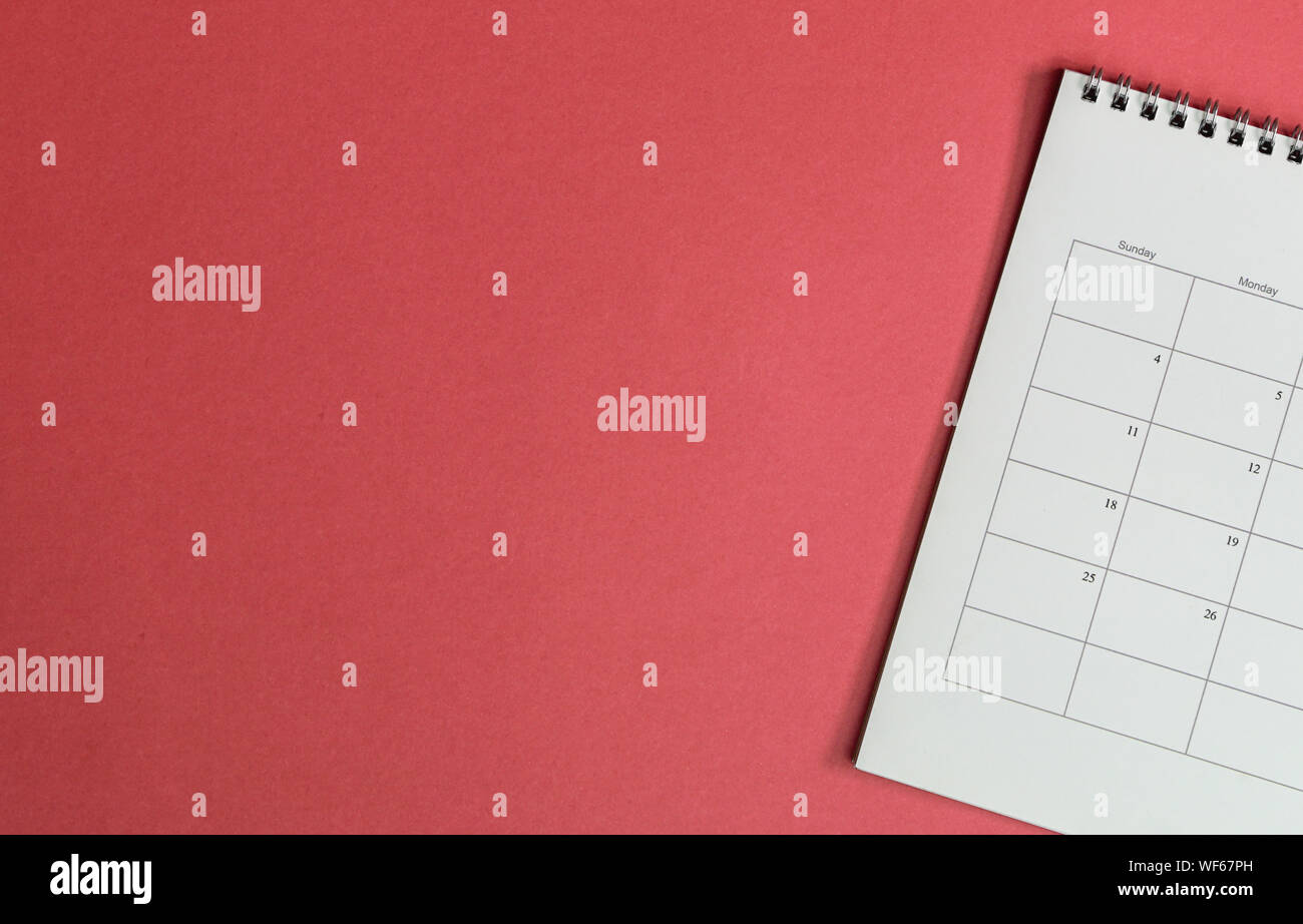Calendar or planner on red background with copy space. Business ...
