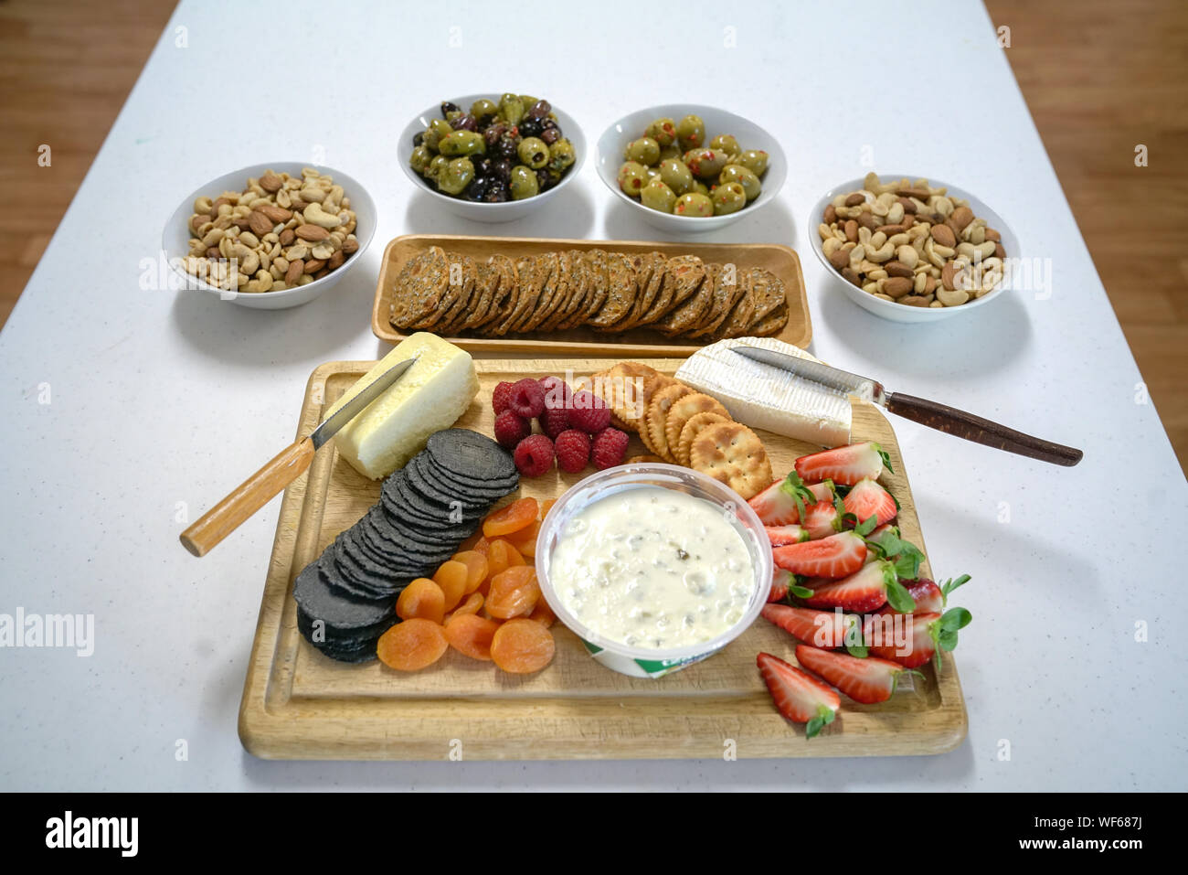 Cocktail or pre dinner snacks consists of crackers, cheese, berries ...