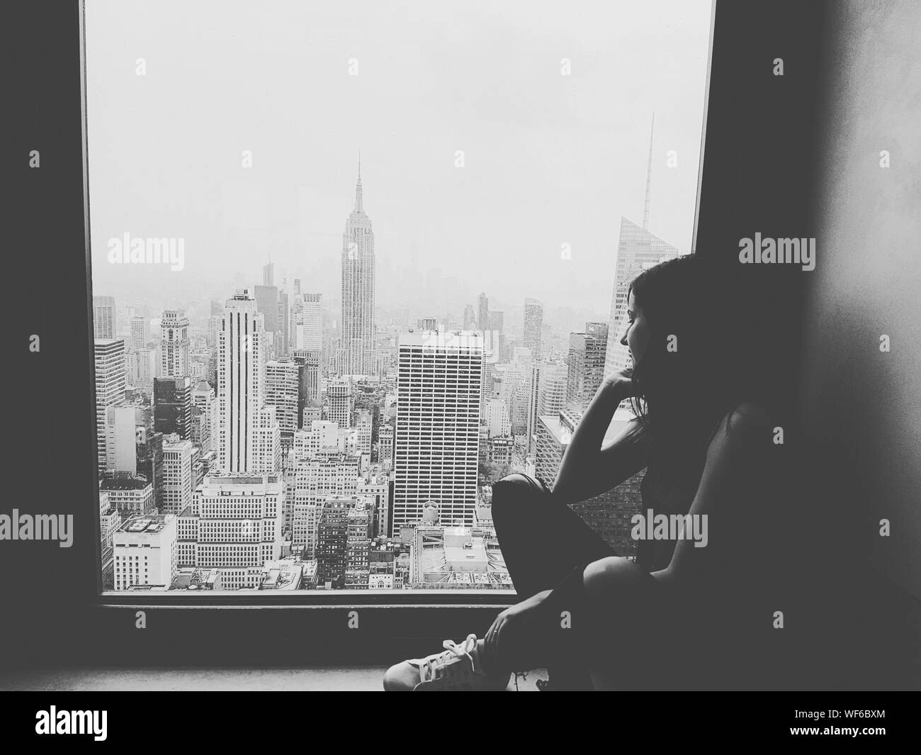 Person looking through window exterior Black and White Stock Photos ...