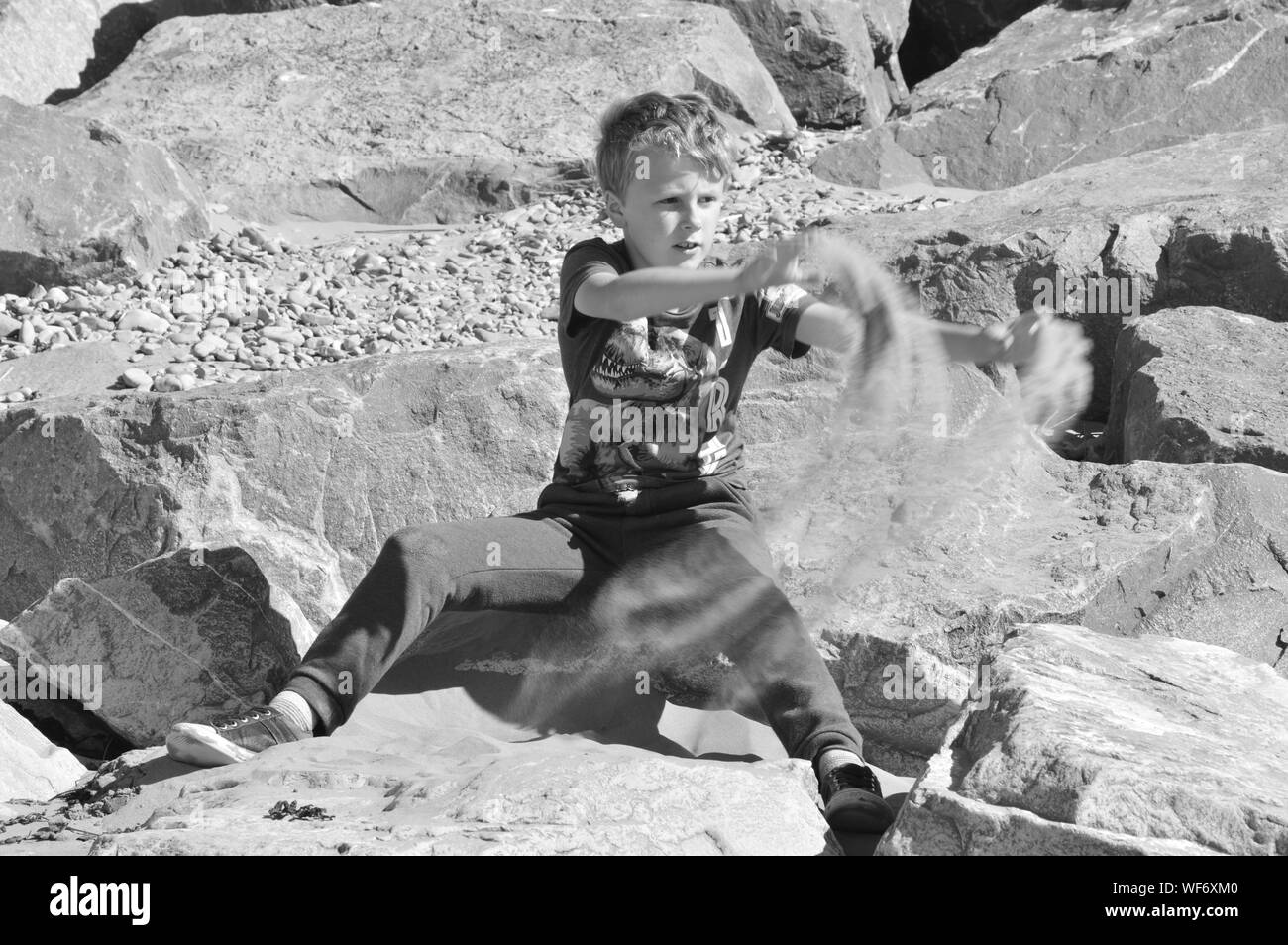 Child throwing rock hi-res stock photography and images - Alamy