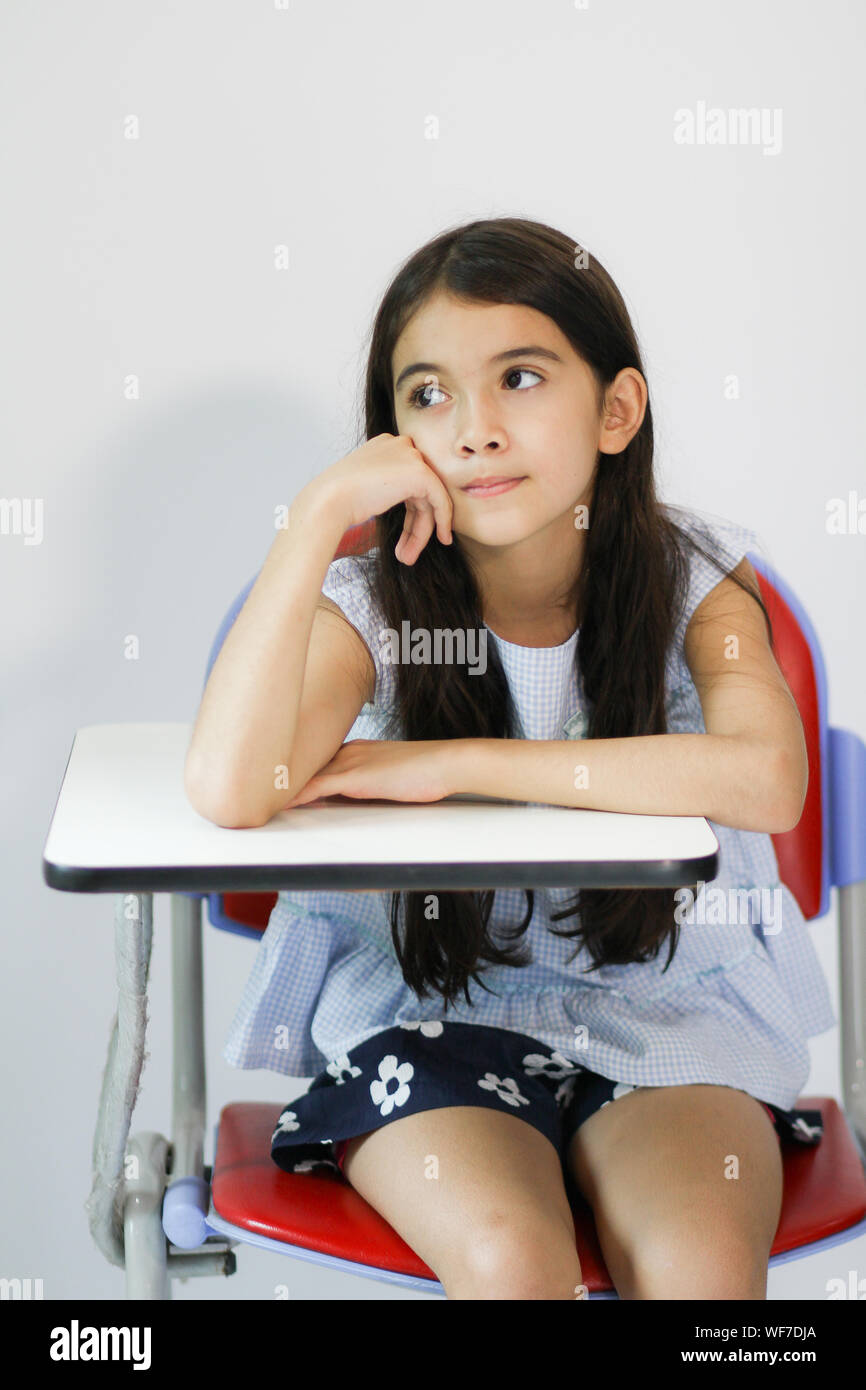 Girl sitting on desk hi-res stock photography and images - Alamy