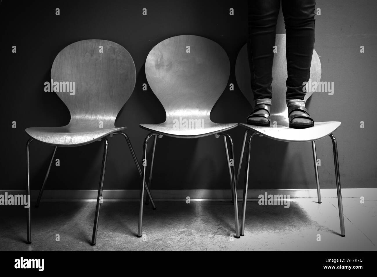 Man Standing On Chair High Resolution Stock Photography and Images - Alamy