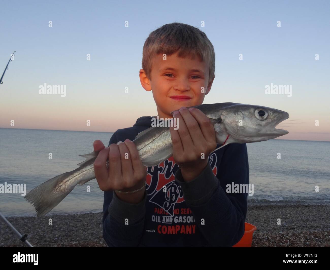 Child holding fishing pole hi-res stock photography and images - Alamy
