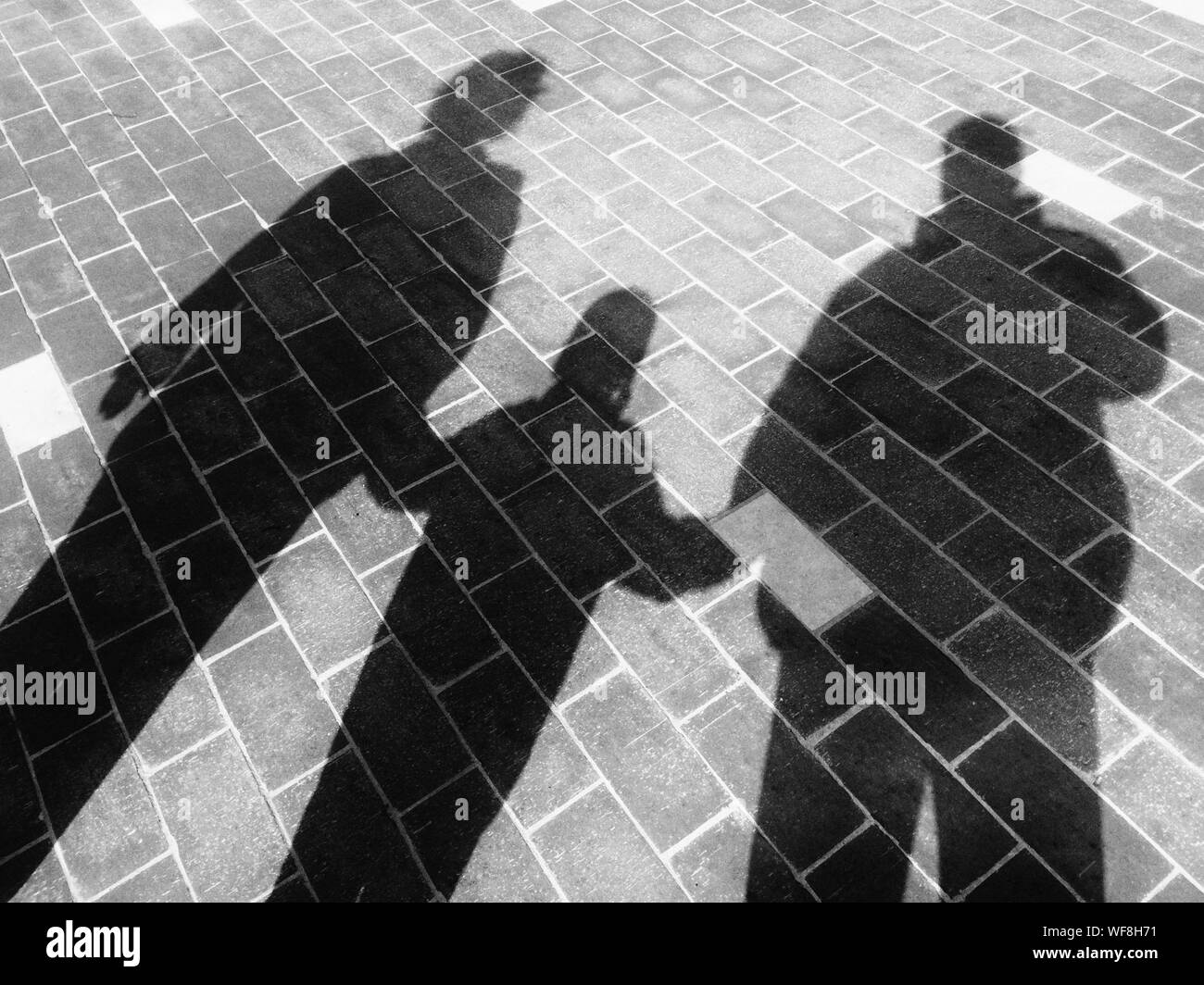 Parents child hands shadow Black and White Stock Photos & Images - Alamy