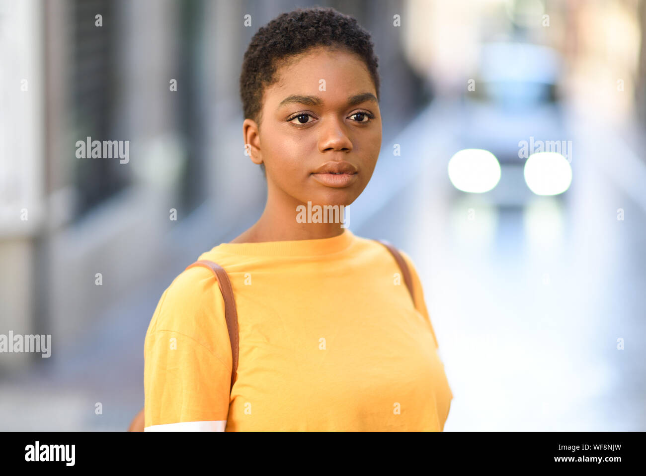 Young African with lost look in urban background Stock Photo - Alamy