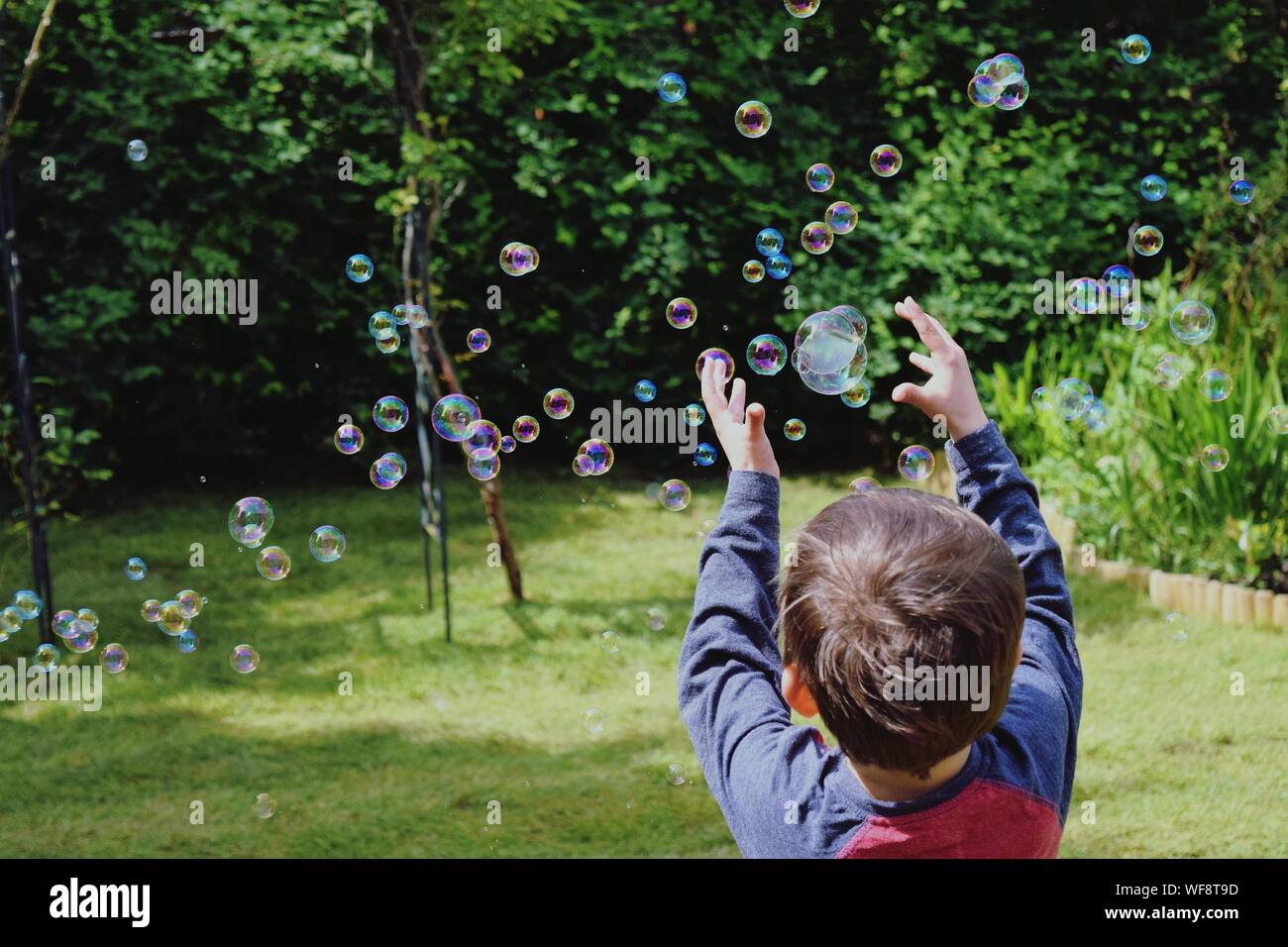 Boy in bubbles hi-res stock photography and images - Alamy