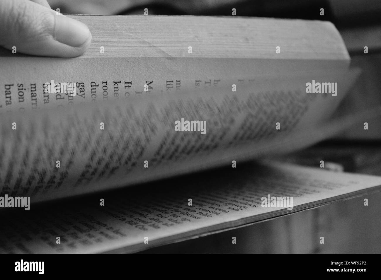 Hand turning page book Black and White Stock Photos & Images - Alamy