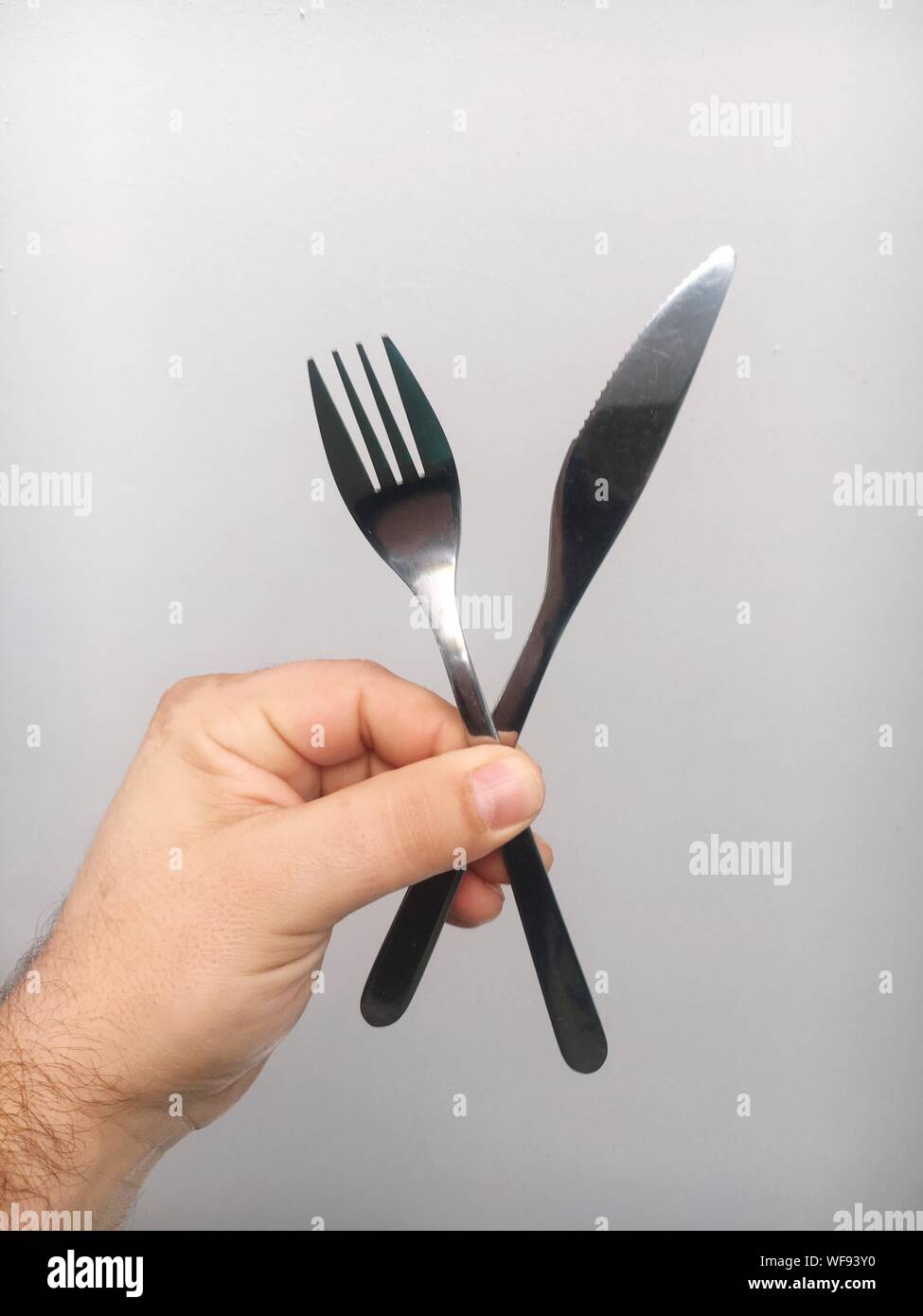 Holding fork and knife hi-res stock photography and images - Alamy
