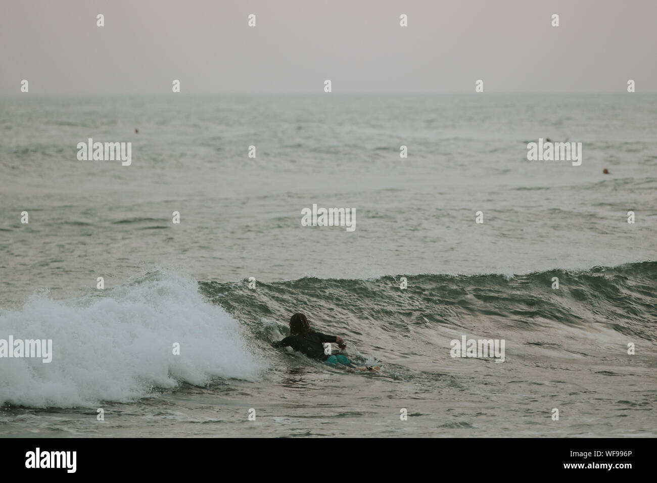 Woman Swimming In Sea At Beach Stock Photo - Alamy