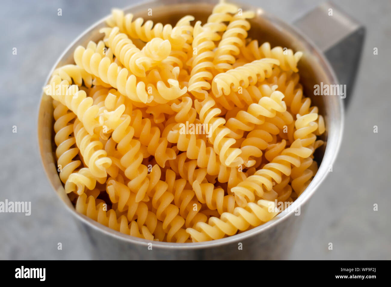 Fusili pasta in stainless container, stock photo Stock Photo - Alamy