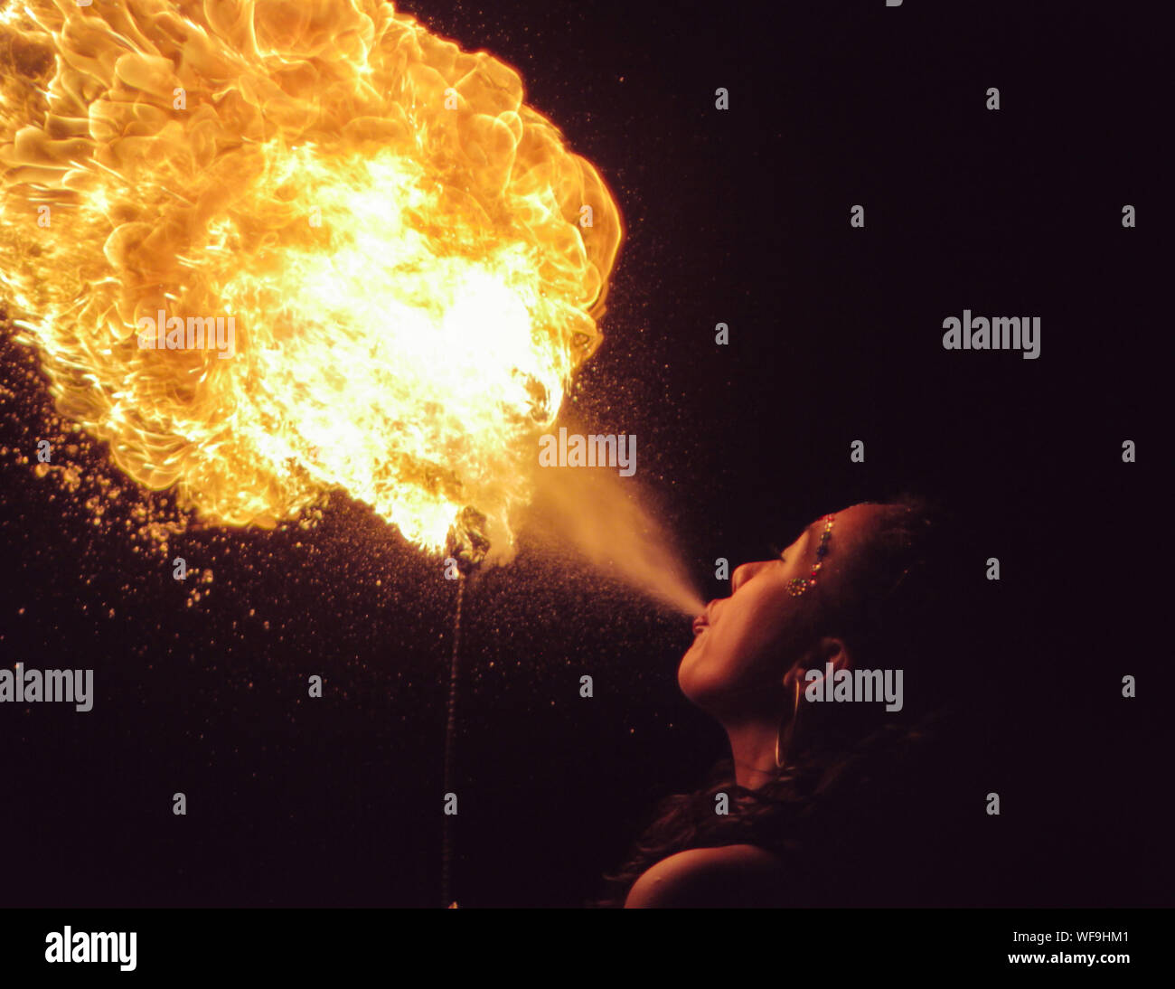 Woman blowing fire hi-res stock photography and images - Alamy