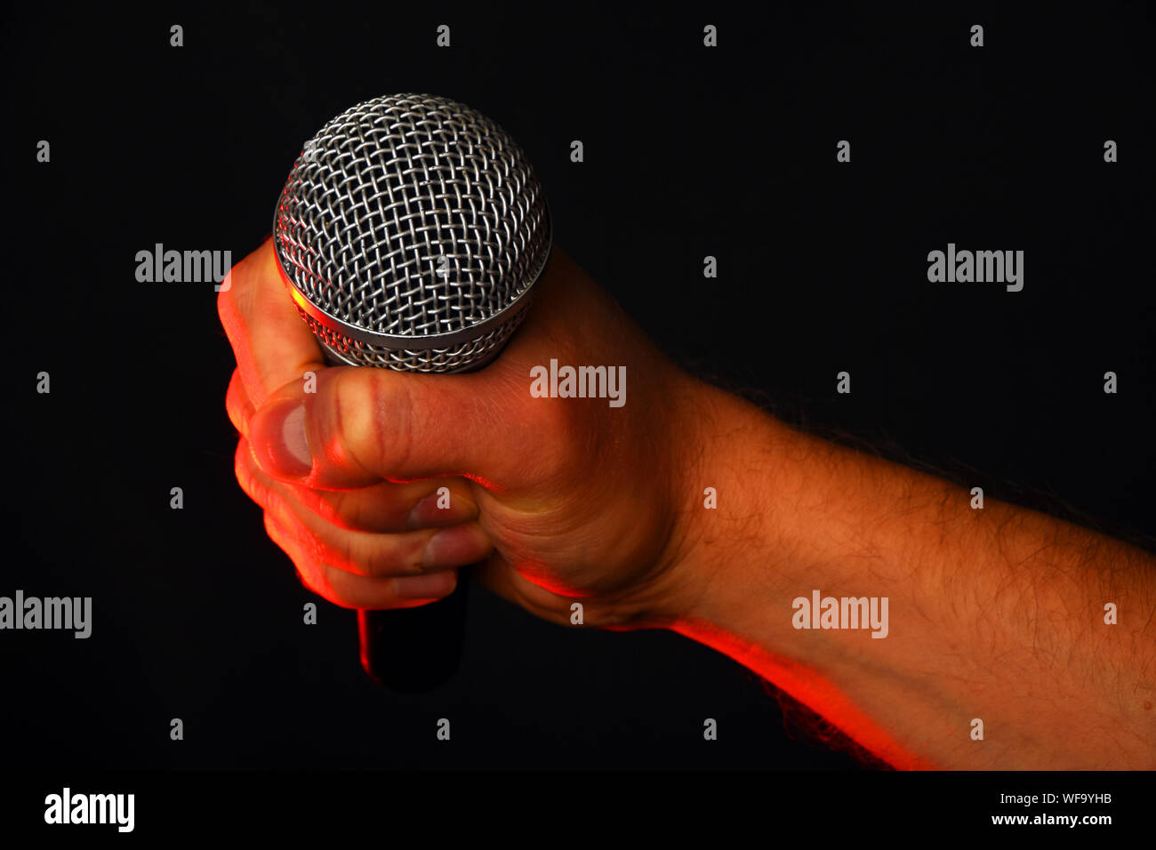 Black hand holding microphone hi-res stock photography and images - Alamy