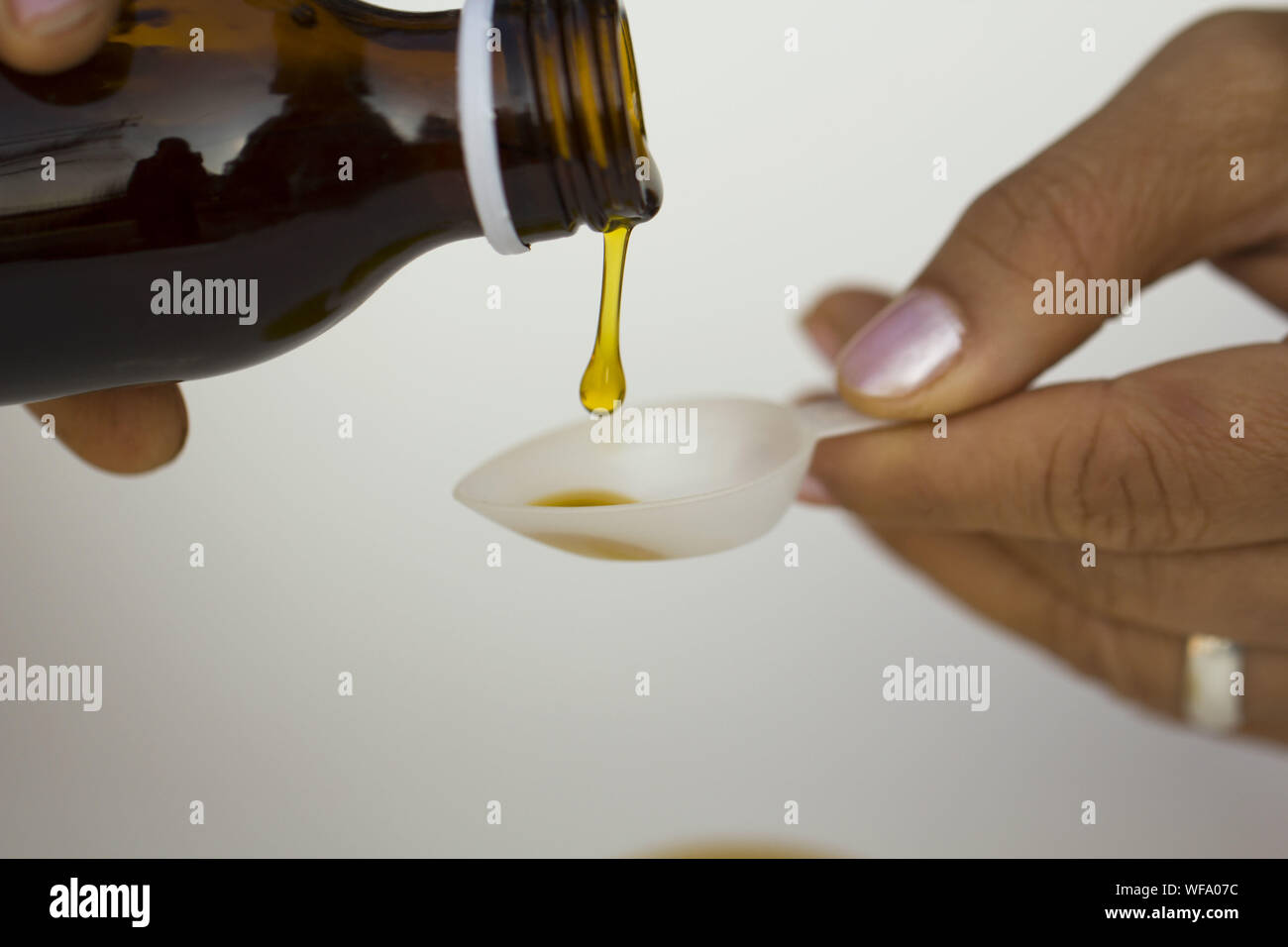 Liquid medicine pouring into spoon hi-res stock photography and images ...
