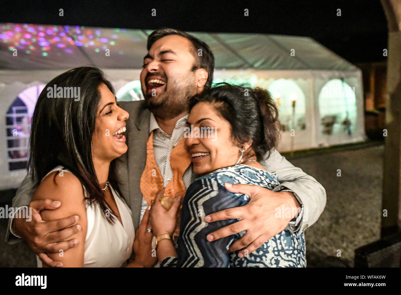 Happy Friends At Party During Night Stock Photo - Alamy
