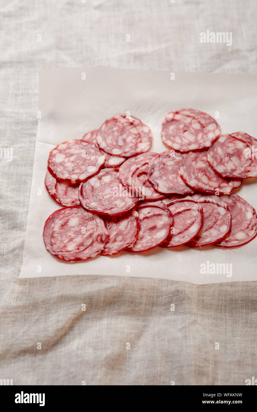 Sliced pork salami on white paper Stock Photo - Alamy
