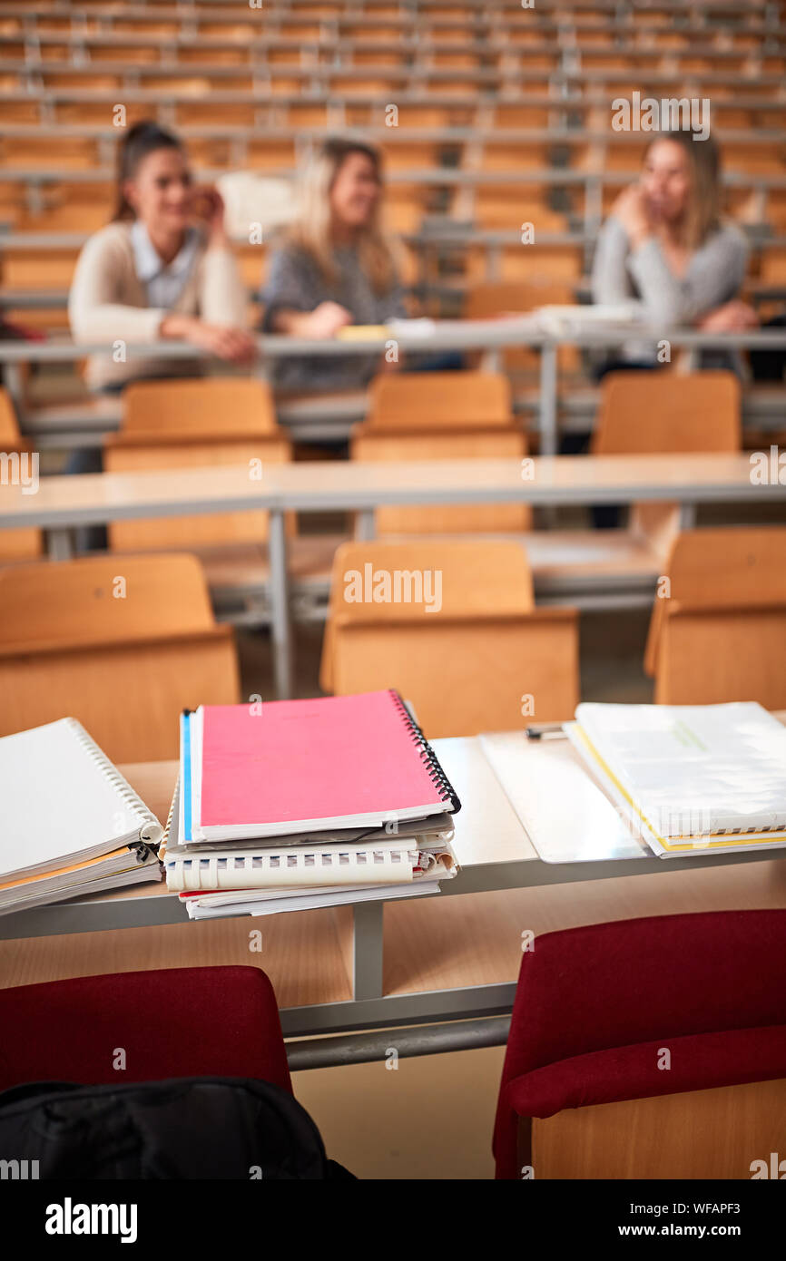books on table in an amphitheater lecture hall or classroom Stock Photo ...