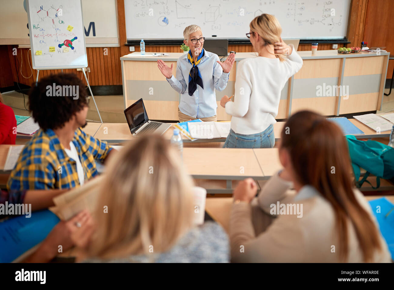 College Students Listening To Teacher