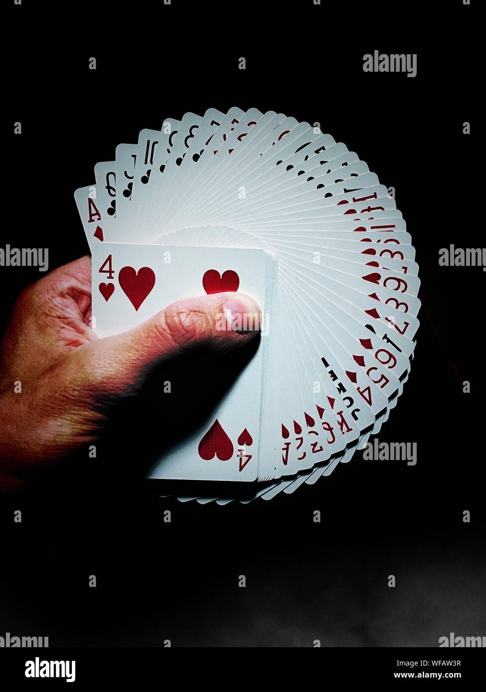 Hand with playing cards hi-res stock photography and images - Alamy