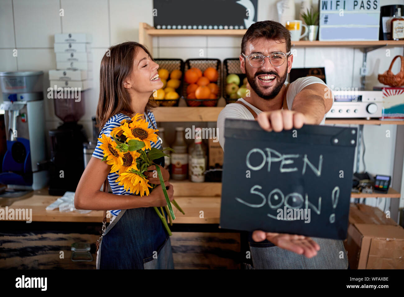 Happy business partners owner with open sign Stock Photo - Alamy