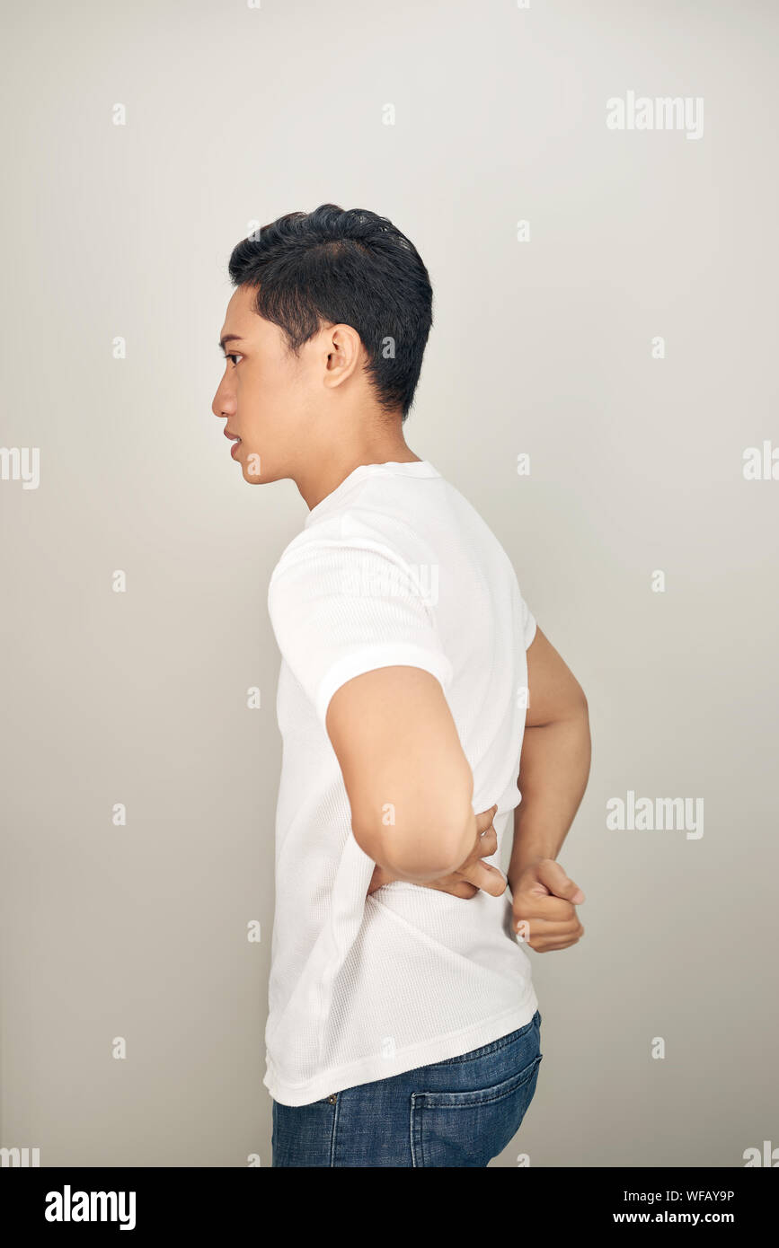 young man with back ache Stock Photo - Alamy