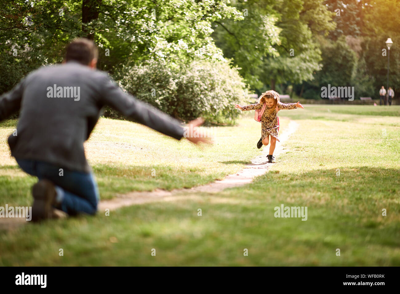 Child running to a parent for a hug hi-res stock photography and images ...
