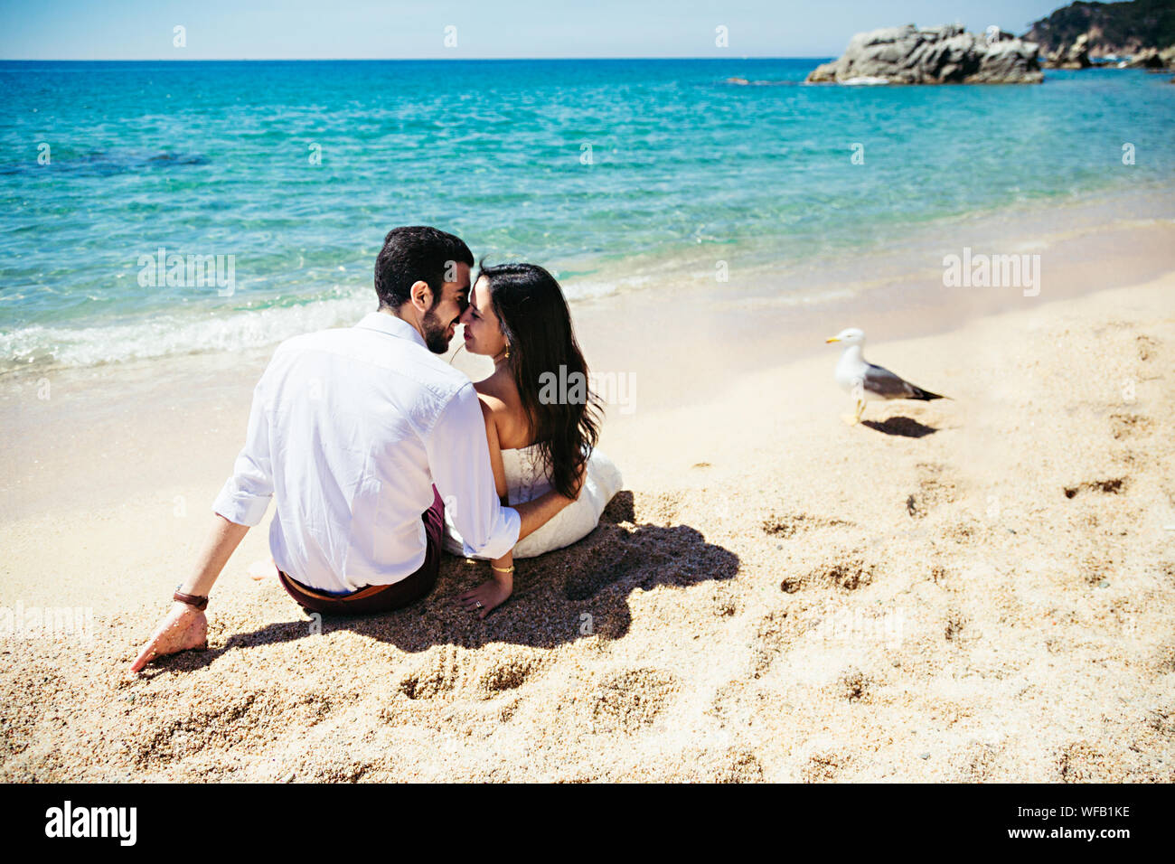 Affectionate young couple kissing beach hi-res stock photography and ...