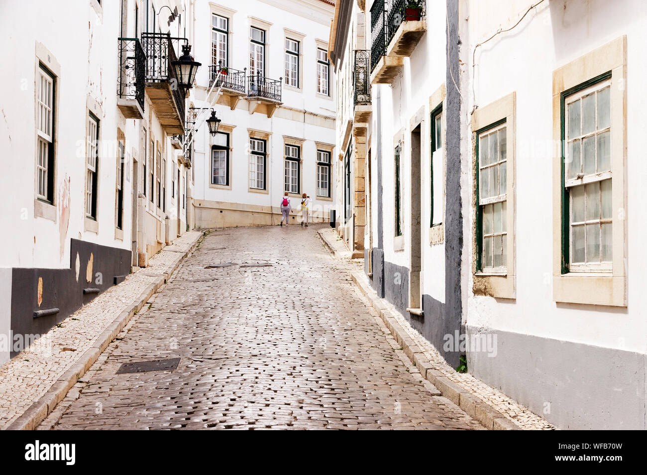 Narrow Road Along Built Structures Stock Photo - Alamy