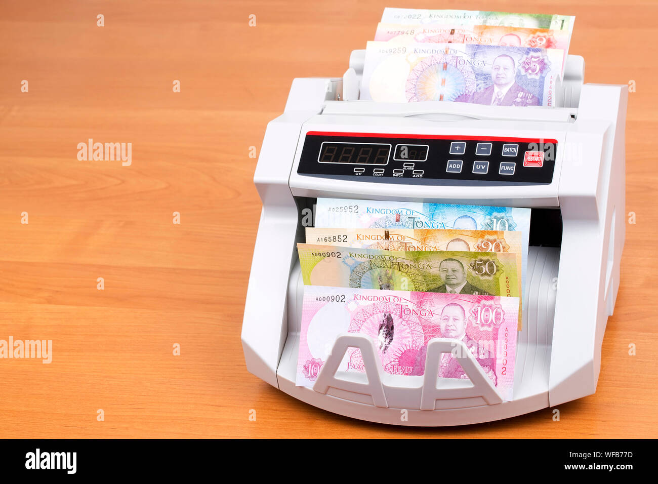 Tongan money in a counting machine Stock Photo - Alamy