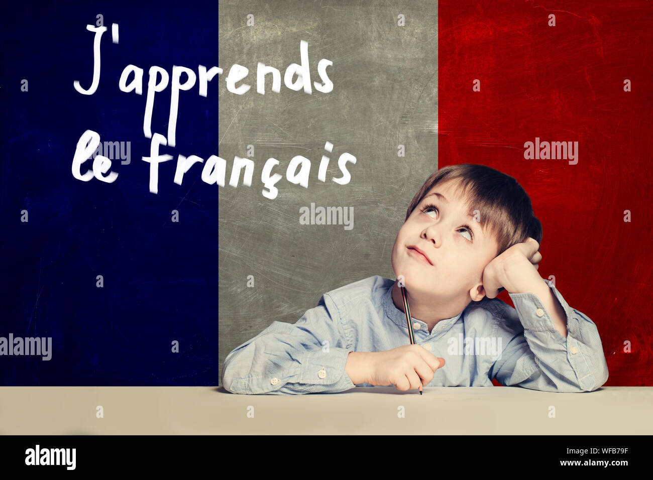 Learn french language concept. Happy child student pointing up on the ...