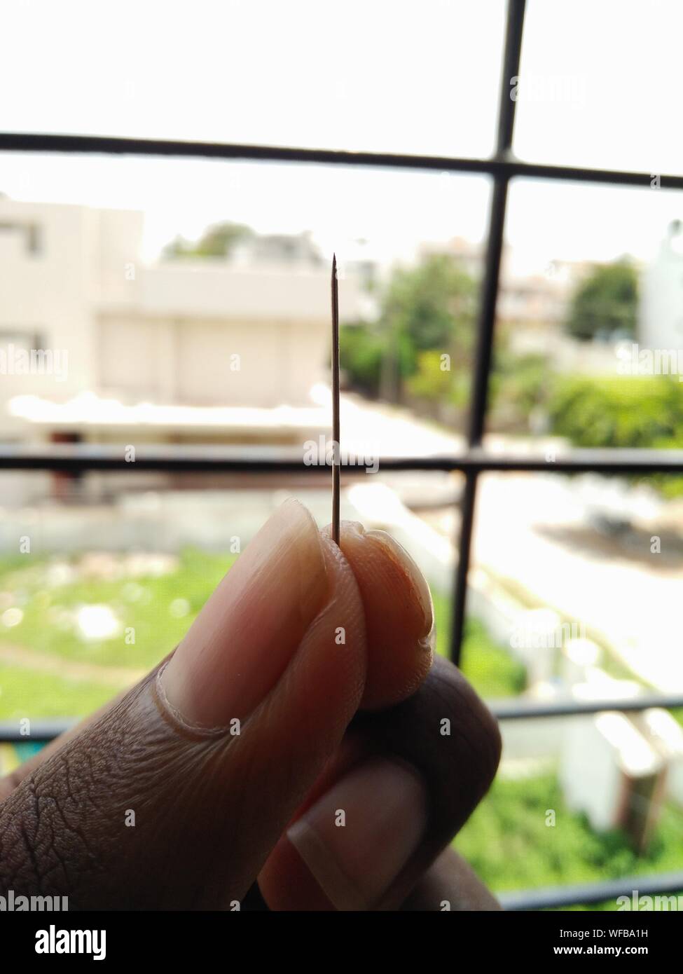 Hand holding pin close up hi-res stock photography and images - Alamy